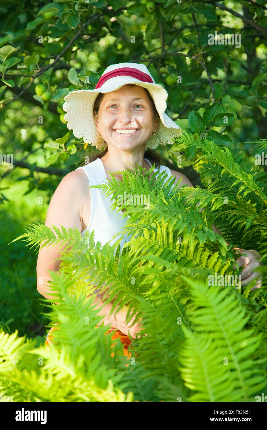 senior woman with ferns im her garden Stock Photo - Alamy
