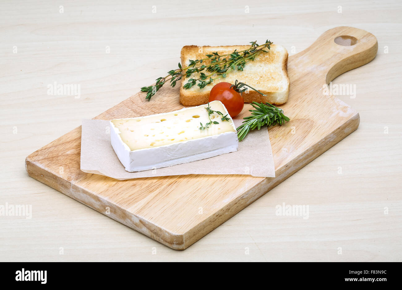 Soft brie cheese with rosemary, thyme and toast bread Stock Photo - Alamy