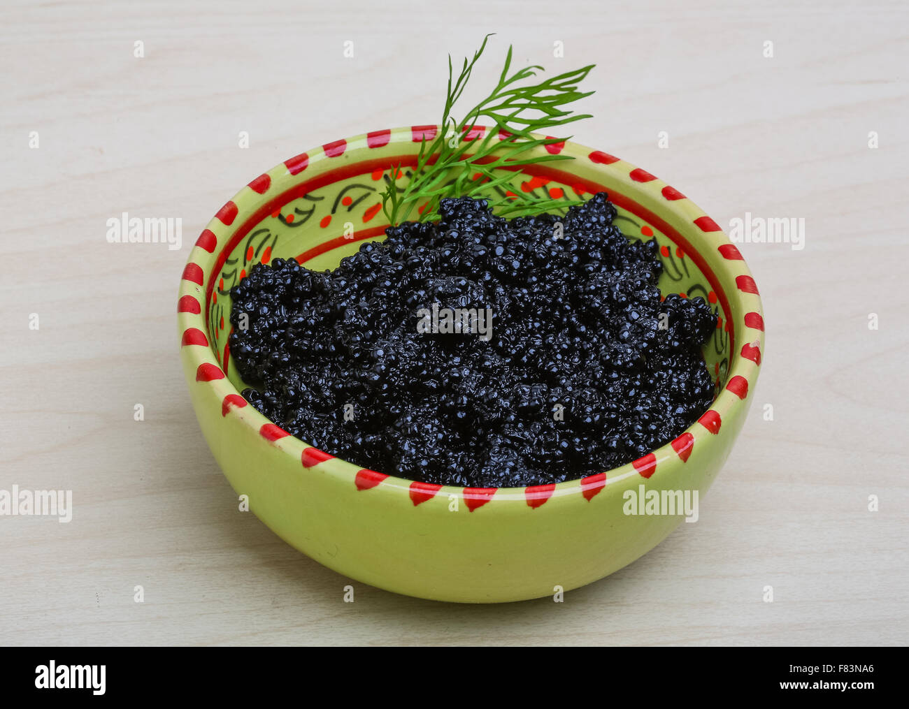 Luxury Black caviar with green herb and lemon Stock Photo - Alamy