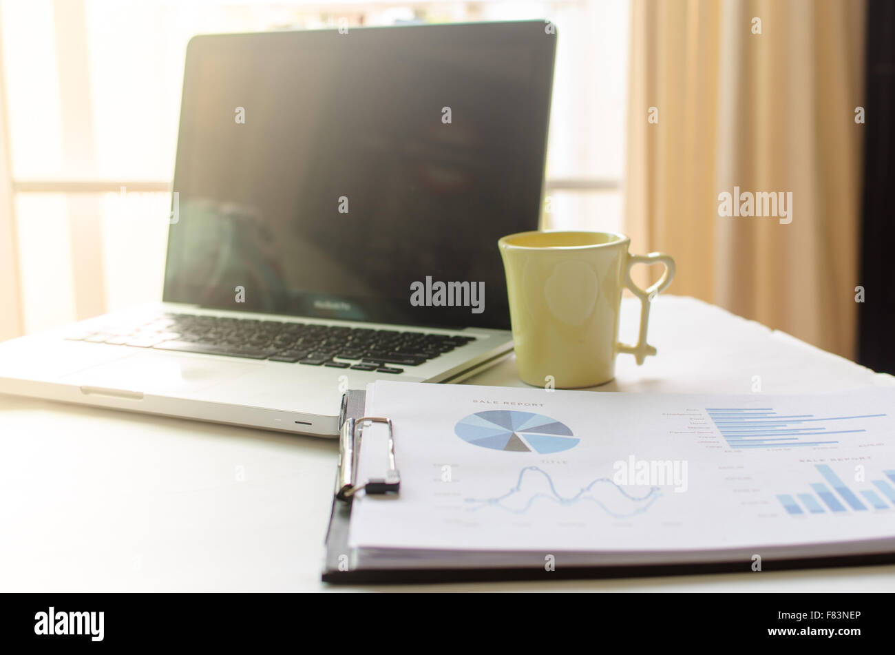 computer laptop and chart on desk Stock Photo - Alamy