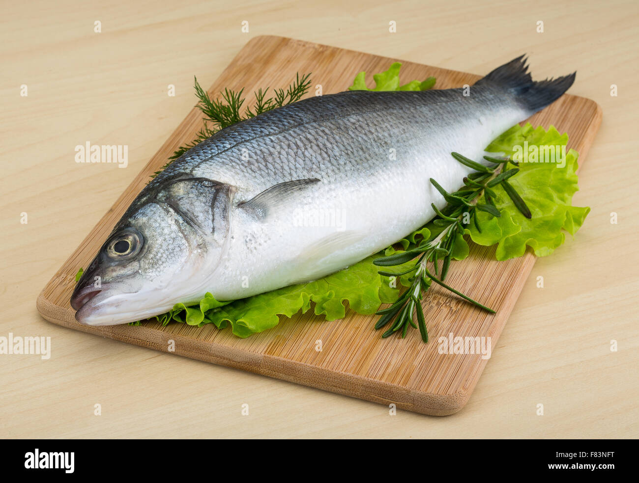 Raw seabass fish with rosemary and dill Stock Photo - Alamy