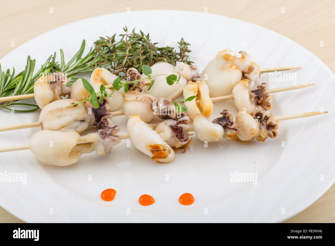 Grilled cuttlefish bbq with rosemary and pepper Stock Photo - Alamy