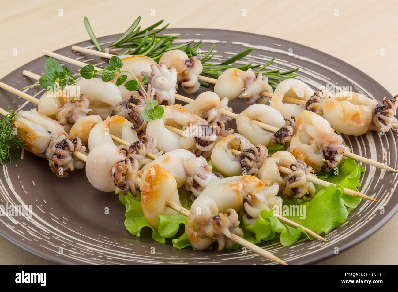 Grilled cuttlefish bbq with rosemary and pepper Stock Photo - Alamy