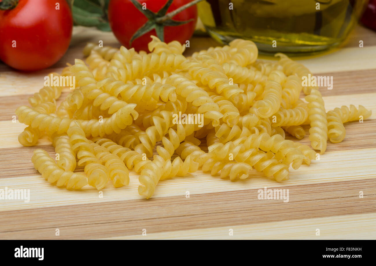 Raw rotini pasta on the wood background Stock Photo - Alamy