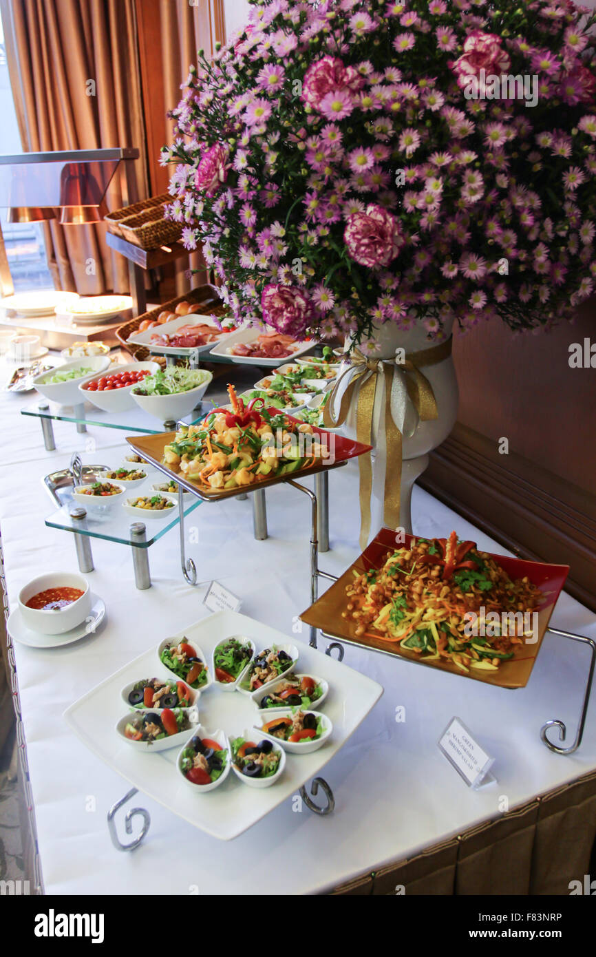 Assorted fresh salads displayed on a buffet, individual containers at ...