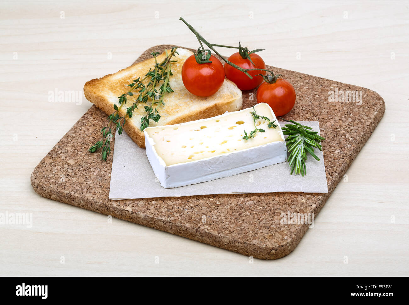 Soft brie cheese with rosemary, thyme and toast bread Stock Photo - Alamy