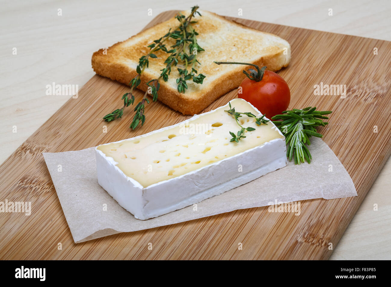 Soft brie cheese with rosemary, thyme and toast bread Stock Photo - Alamy