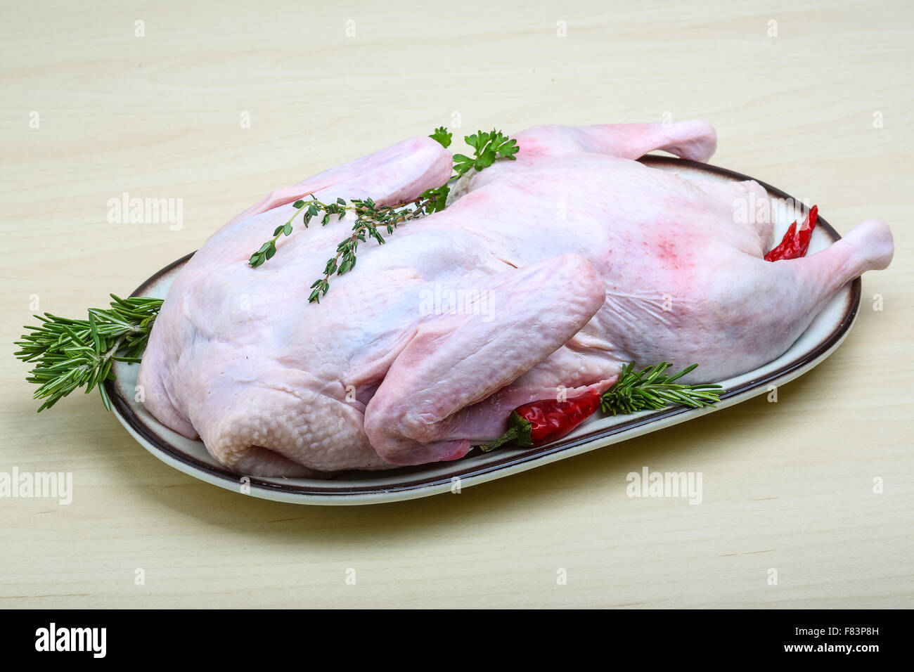 Raw duck with rosemary and spices - ready for cooking Stock Photo - Alamy