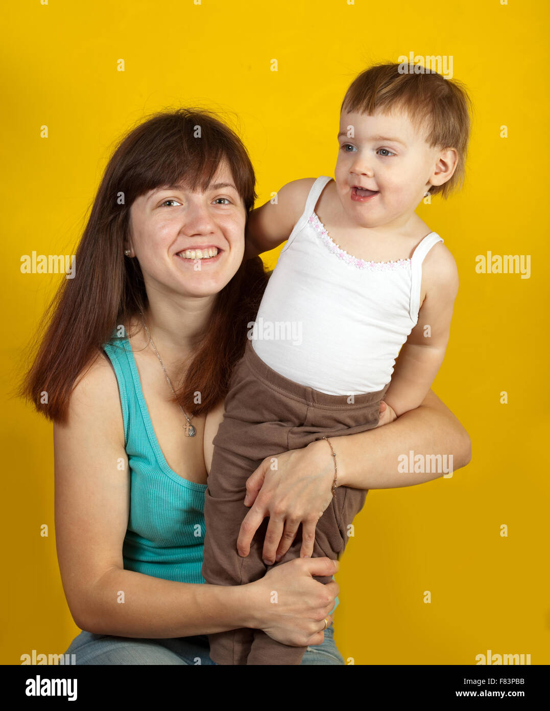 mother with her child over yellow background Stock Photo - Alamy