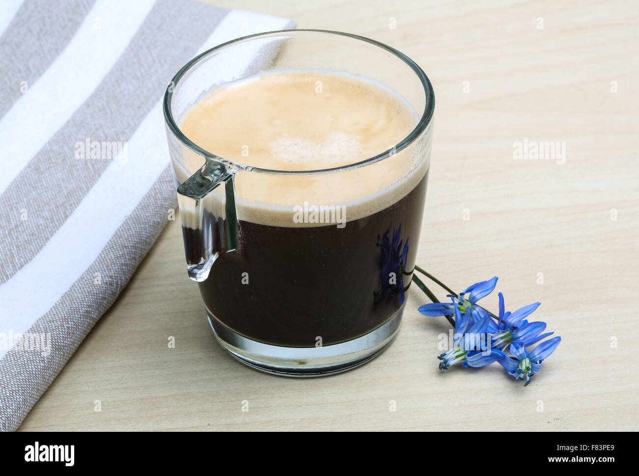 Hot Espresso coffee with blue spring flowers Stock Photo - Alamy