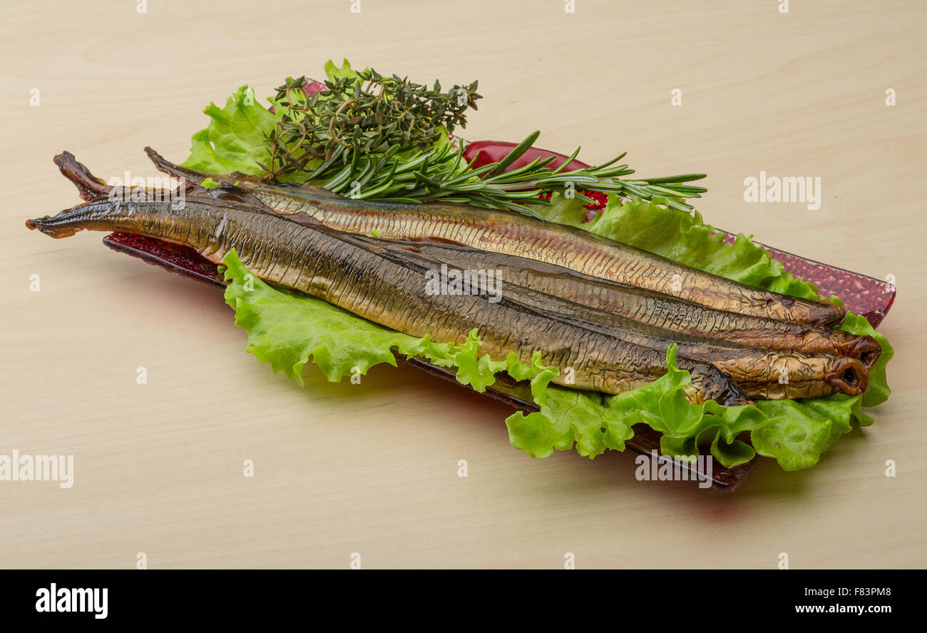 Smoked Lamprey - seafood delicacy with salad and herbs Stock Photo - Alamy