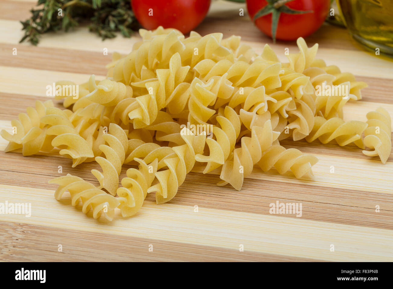 Raw fusilli pasta on the wood background Stock Photo - Alamy