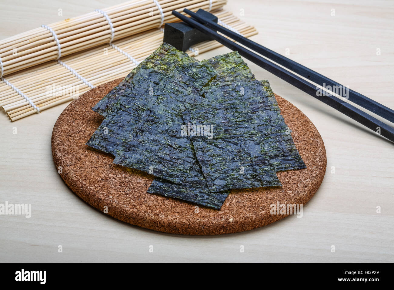 Nori sheets with sticks on the wood background Stock Photo - Alamy