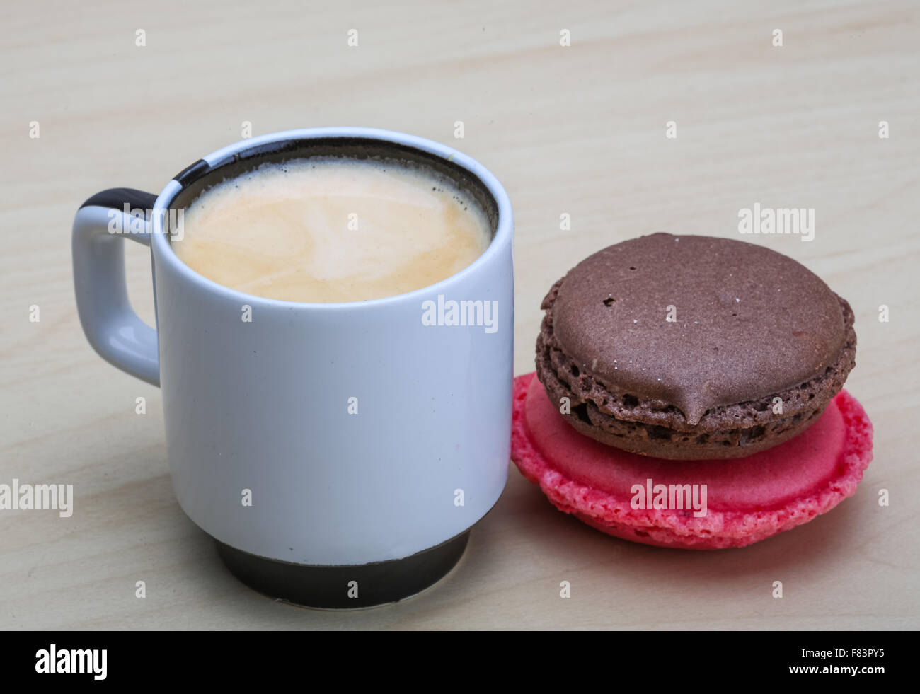 Espresso with two macaroons on the wood background Stock Photo - Alamy
