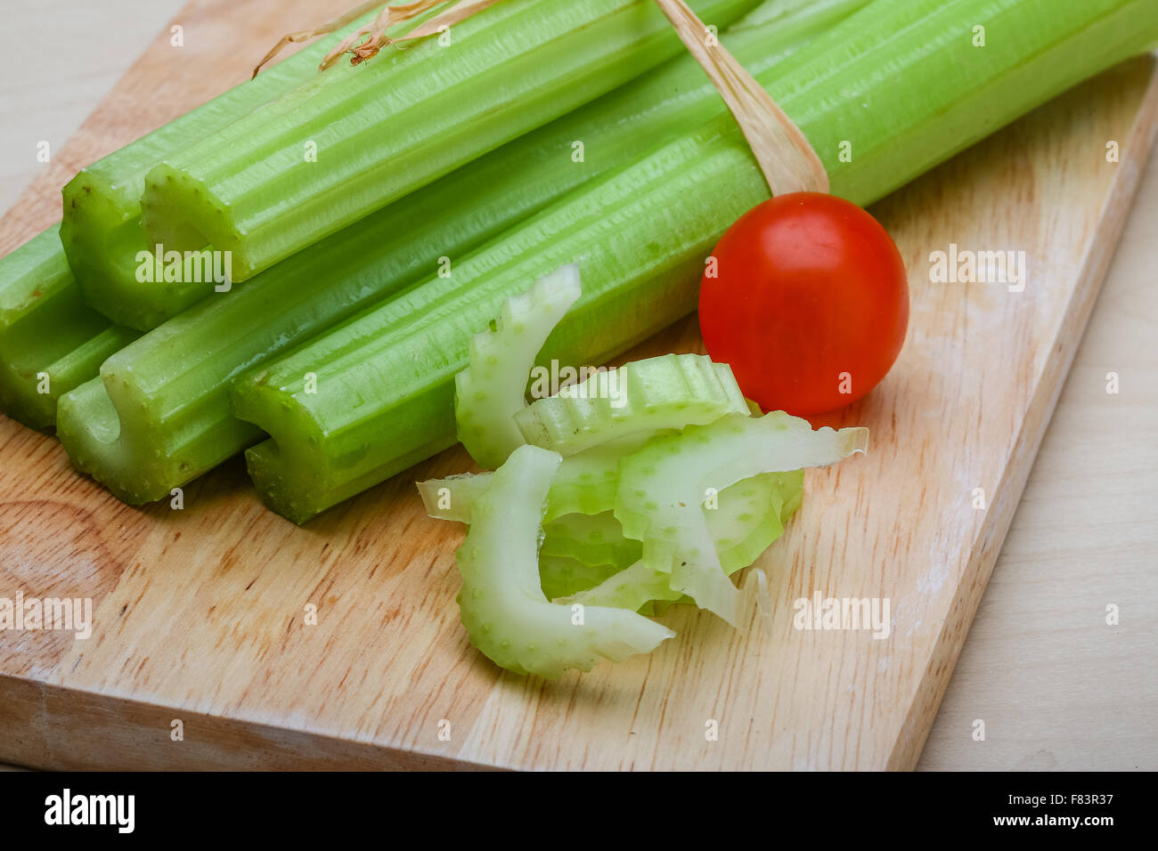 Fresh Green Celery sticks on the wood background Stock Photo - Alamy