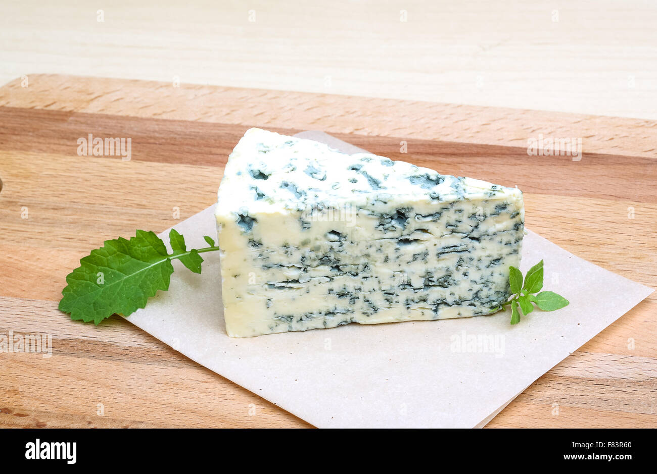 Dor Blue cheese with basil on the wood background Stock Photo - Alamy