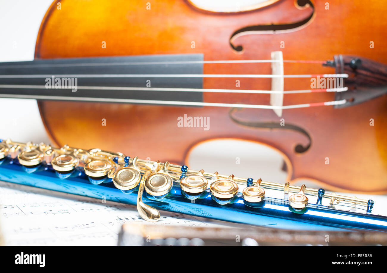 Blue flute detail with out of focus wooden violin and score Stock Photo ...