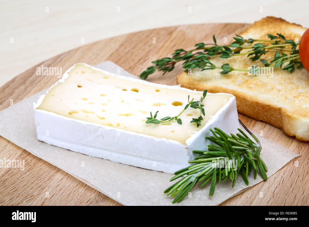 Soft brie cheese with rosemary, thyme and toast bread Stock Photo - Alamy