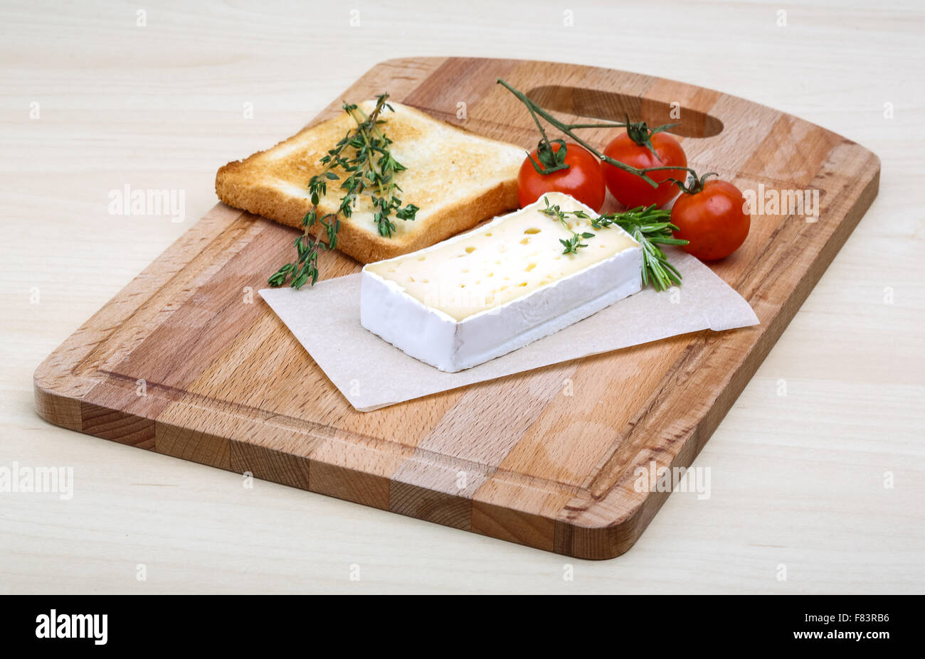 Soft brie cheese with rosemary, thyme and toast bread Stock Photo - Alamy