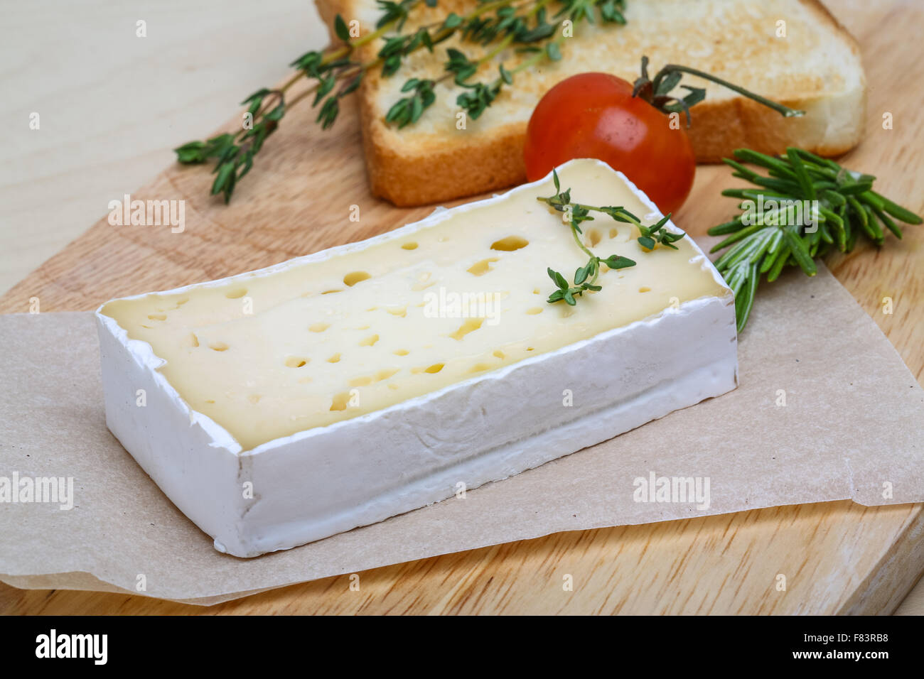 Soft brie cheese with rosemary, thyme and toast bread Stock Photo - Alamy