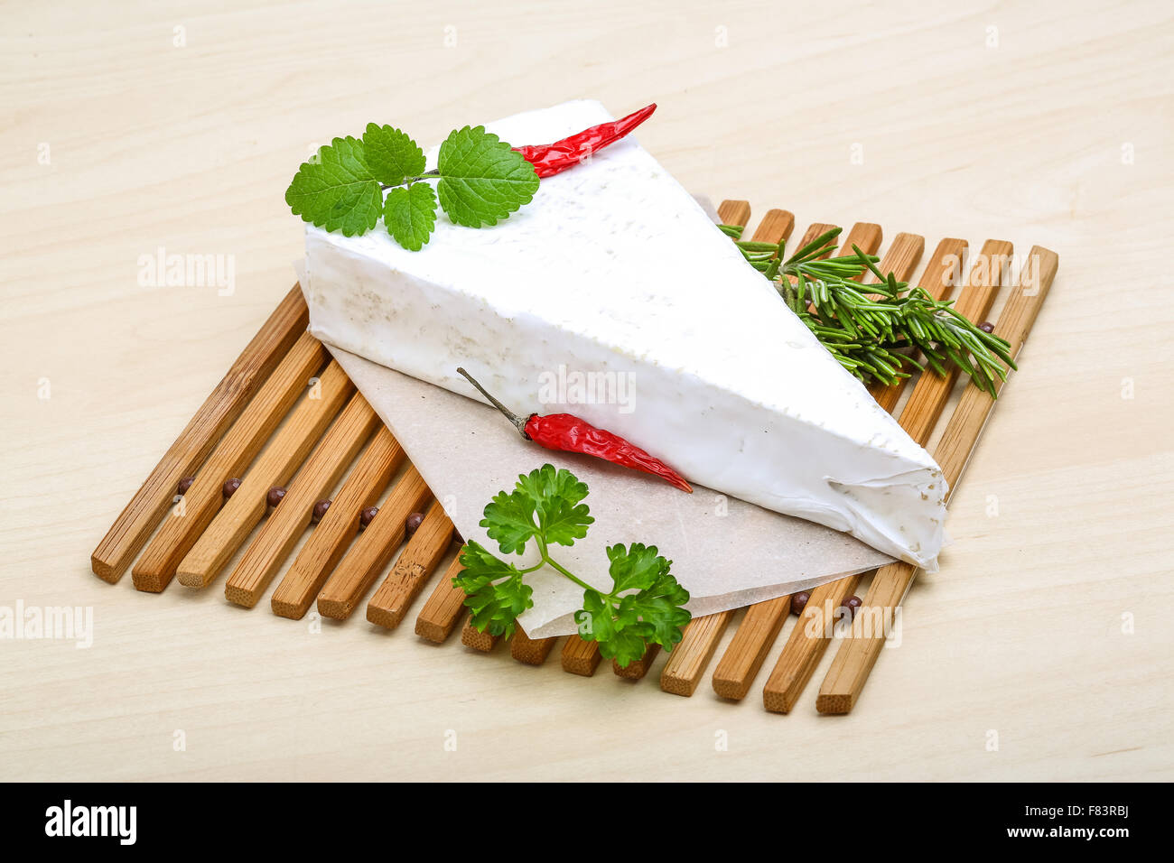 Soft brie cheese with rosemary, thyme on the wood background Stock ...