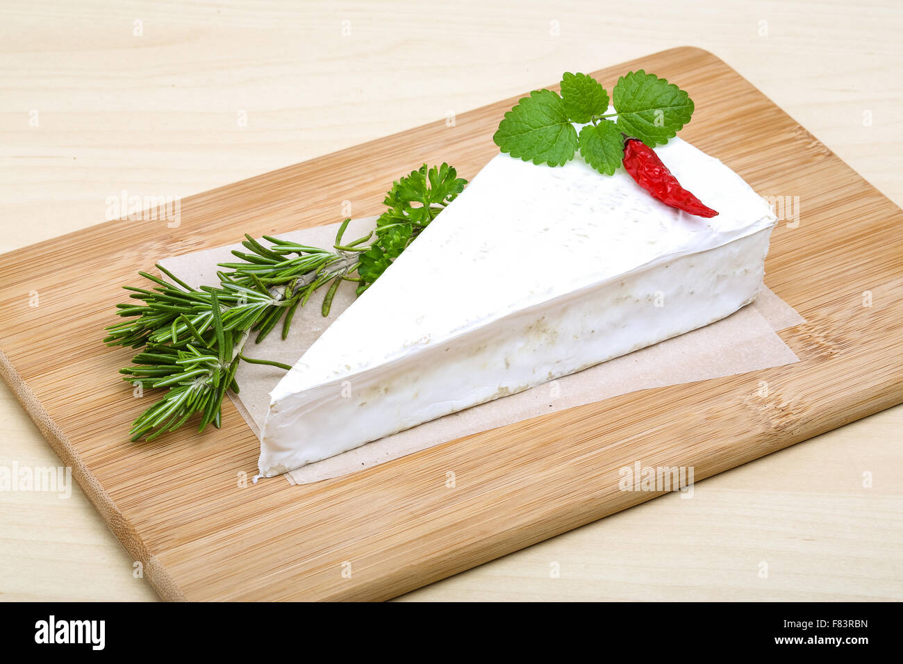 Soft brie cheese with rosemary, thyme on the wood background Stock ...