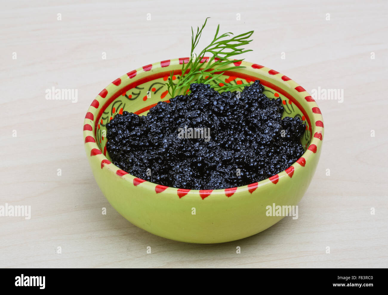 Luxury Black caviar with green herb and lemon Stock Photo - Alamy
