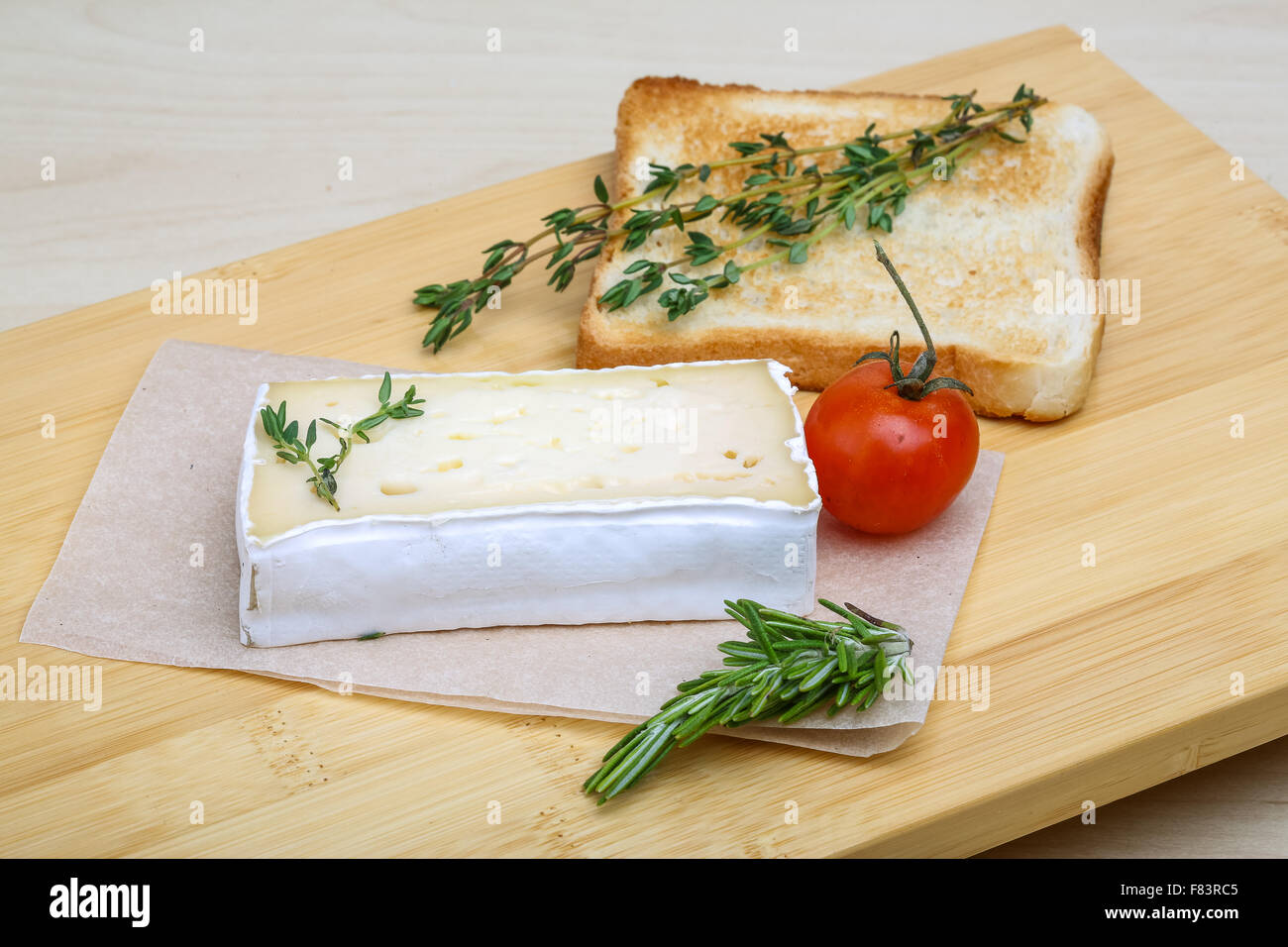 Soft brie cheese with rosemary, thyme and toast bread Stock Photo - Alamy