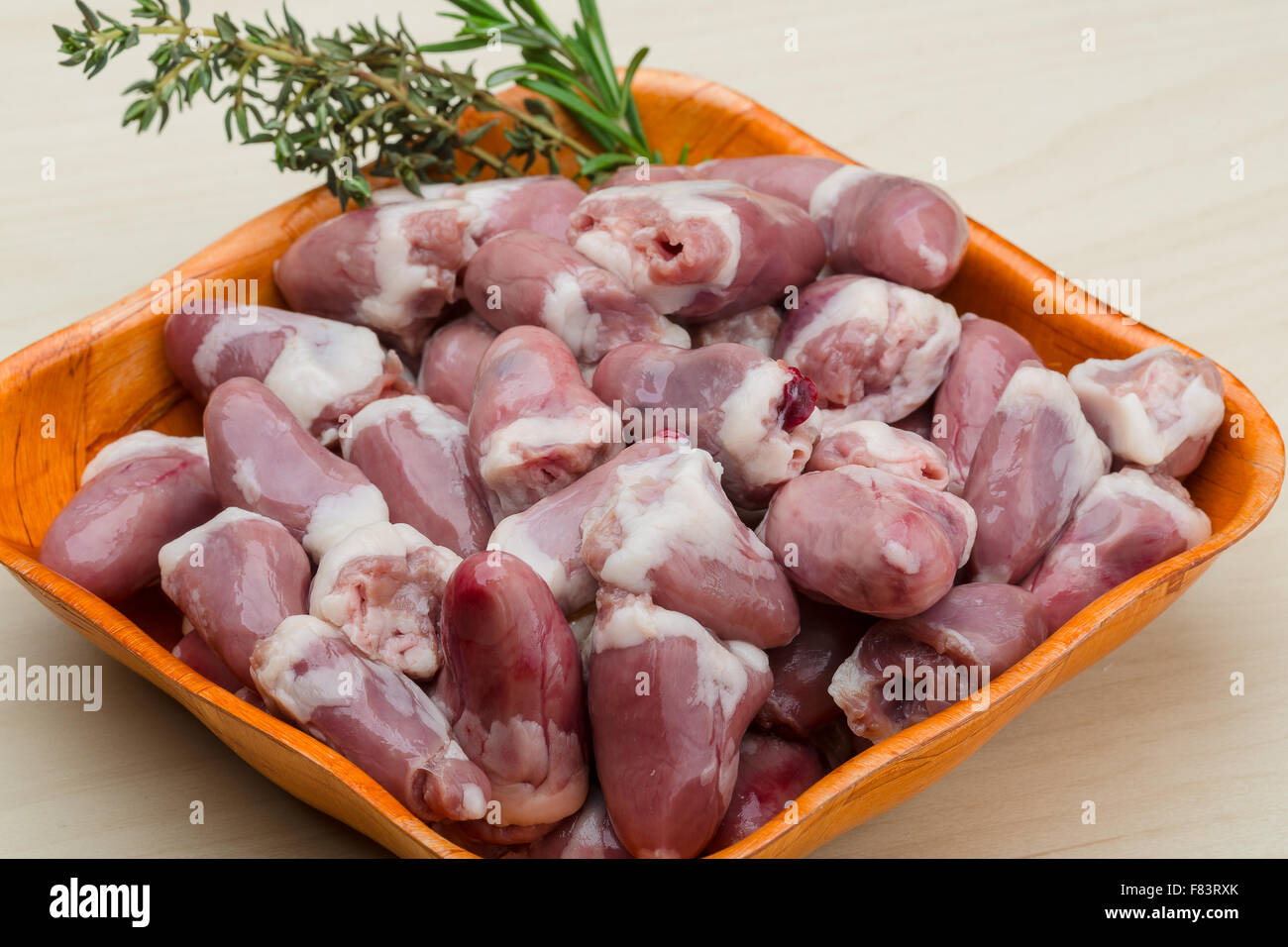Raw chicken hearts with thyme and rosemary - ready for cooking Stock ...