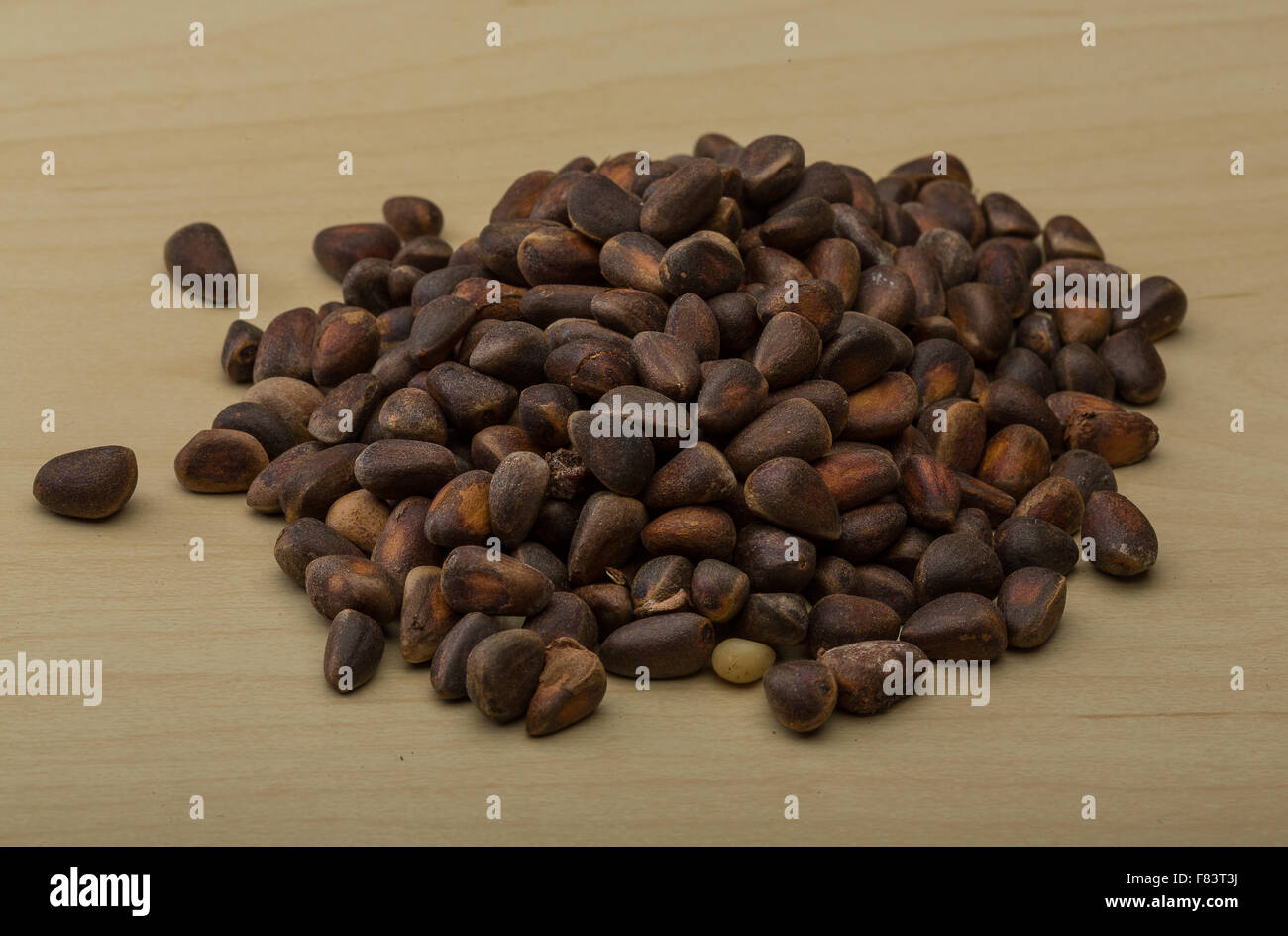 Brown Cedar nut on the wood background Stock Photo - Alamy