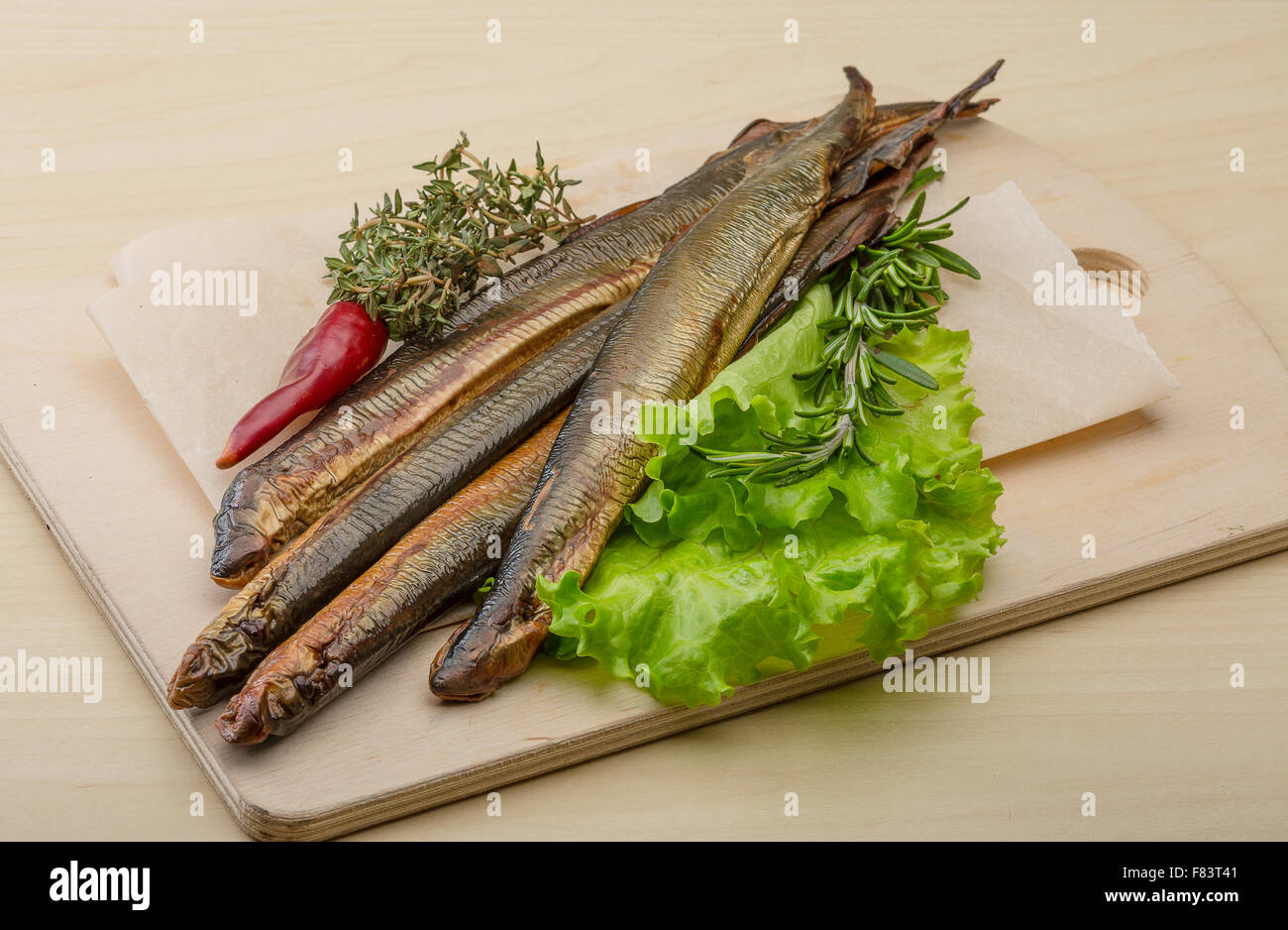 Smoked Lamprey - seafood delicacy with salad and herbs Stock Photo - Alamy