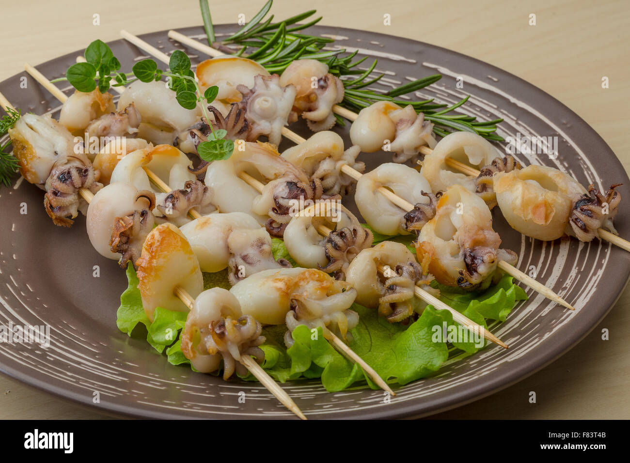 Grilled cuttlefish bbq with rosemary and pepper Stock Photo - Alamy
