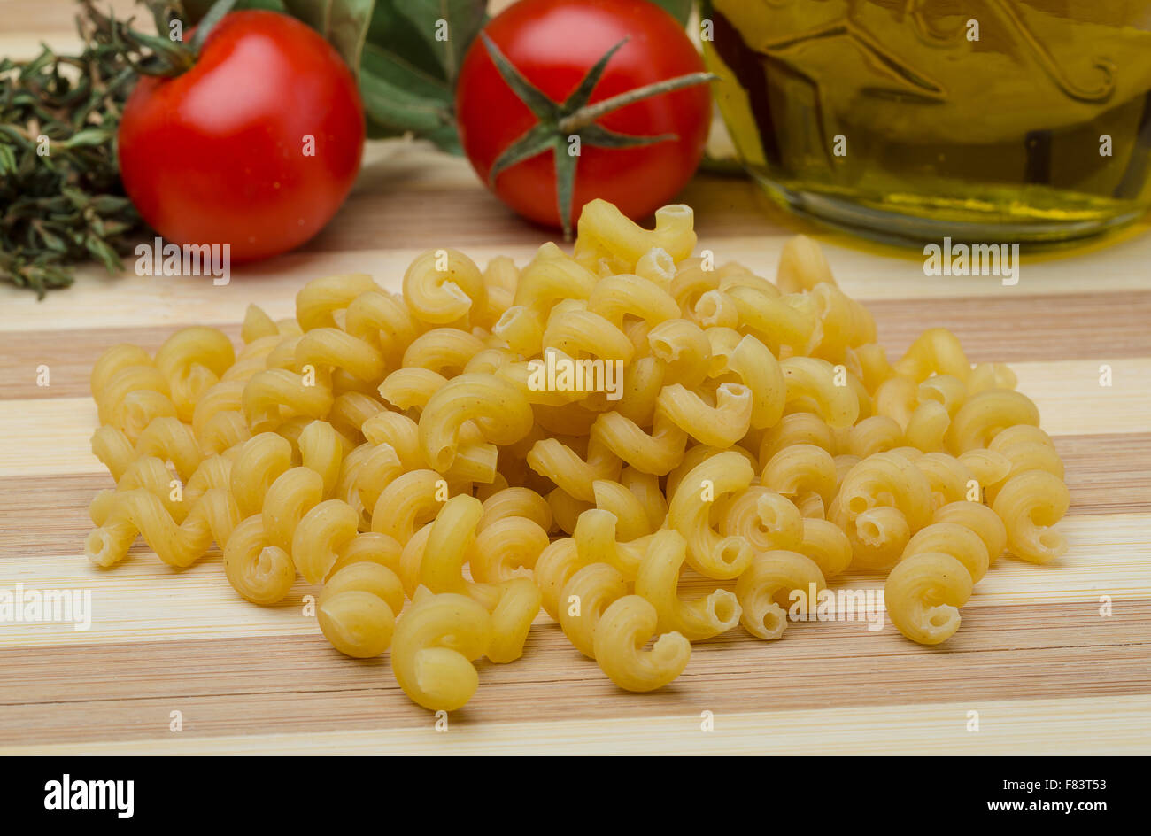 Raw Cellentani pasta on the wood background Stock Photo - Alamy