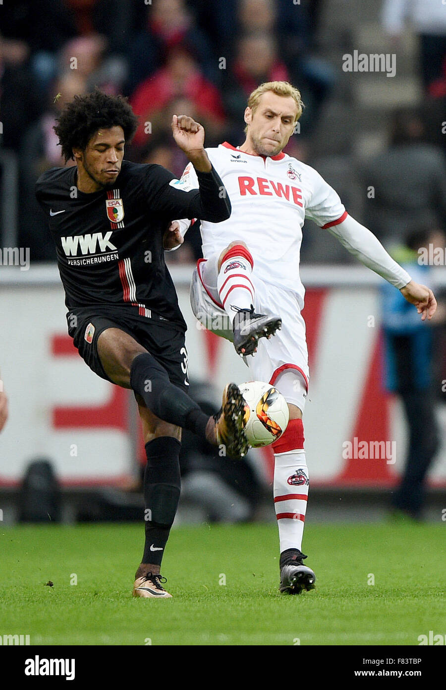 Cologne, Germany. 5th Dec, 2015. Augsburg's Caiuby (l) and Cologne's ...