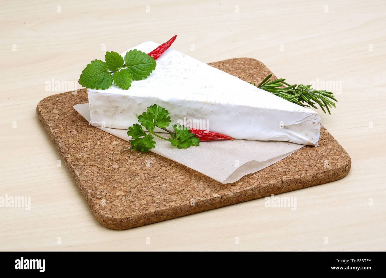 Soft brie cheese with rosemary, thyme on the wood background Stock ...