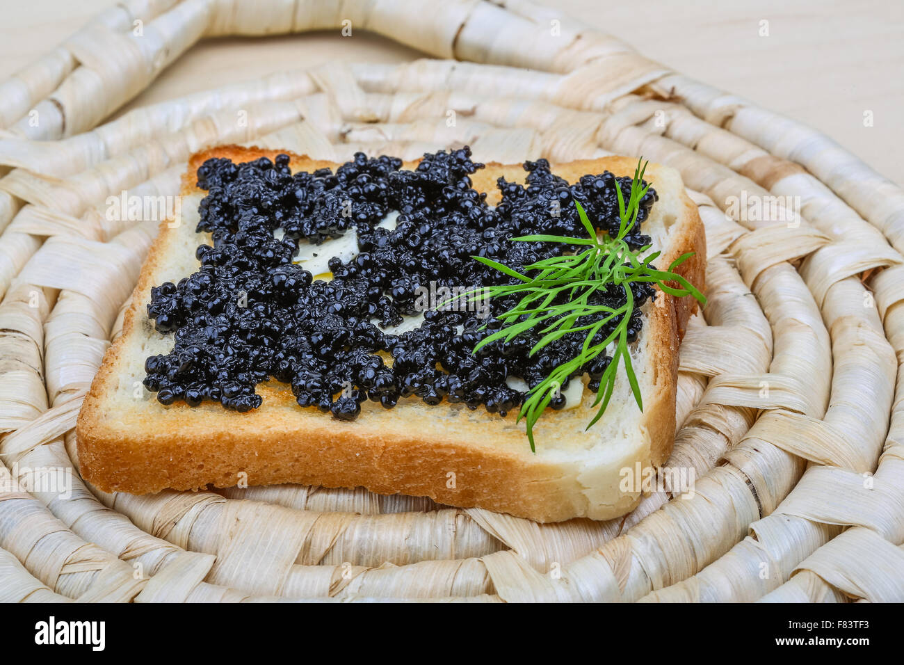 Black caviar toast with green dill branch Stock Photo - Alamy