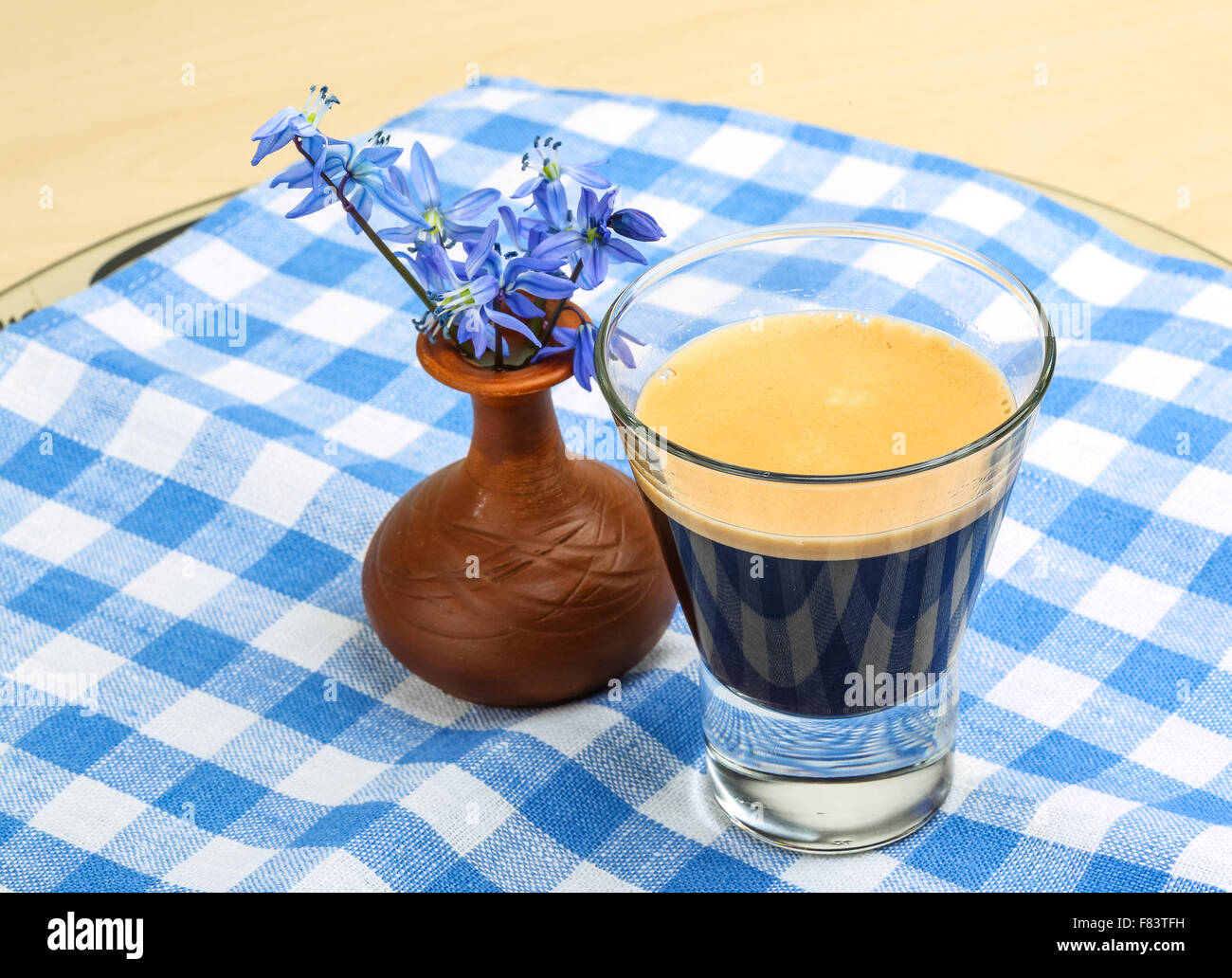 Hot Espresso coffee with blue spring flowers Stock Photo - Alamy