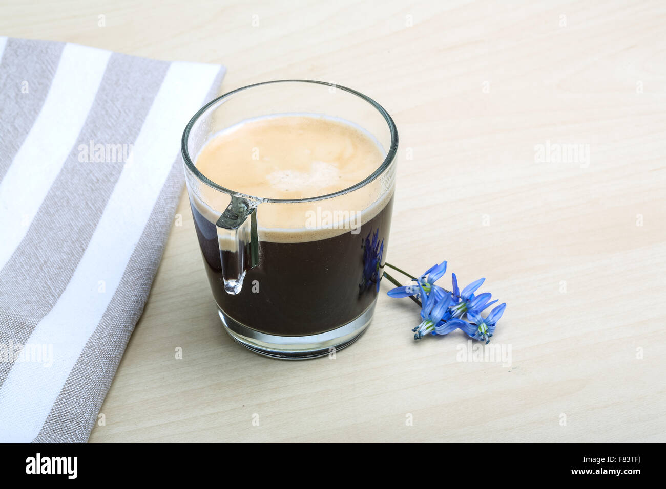 Hot Espresso coffee with blue spring flowers Stock Photo - Alamy