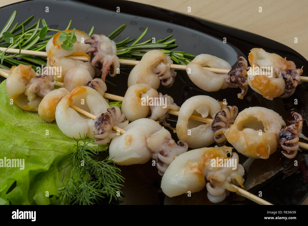 Grilled cuttlefish bbq with rosemary and pepper Stock Photo - Alamy