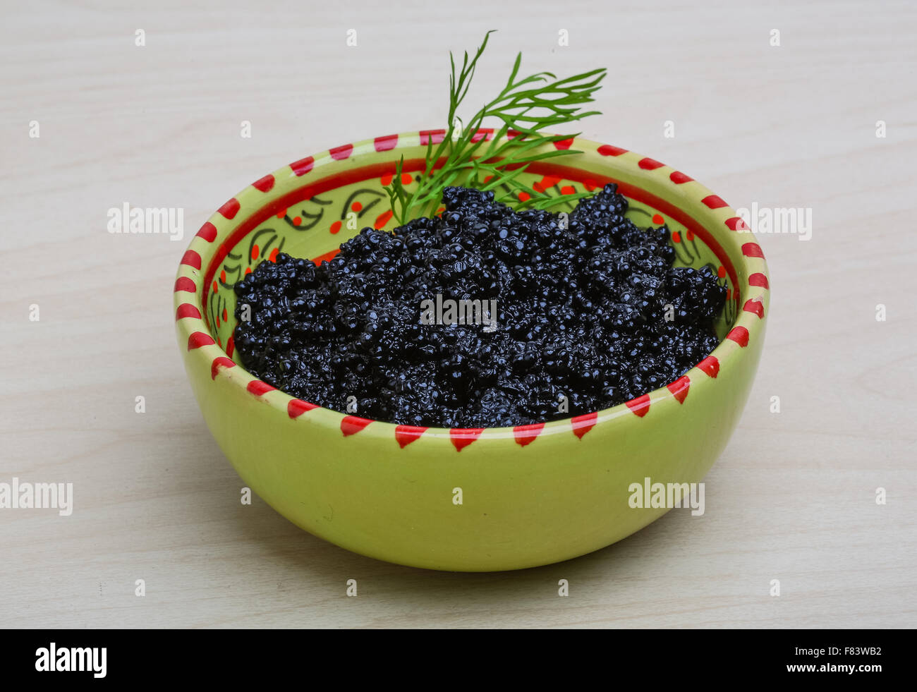 Luxury Black caviar with green herb and lemon Stock Photo - Alamy