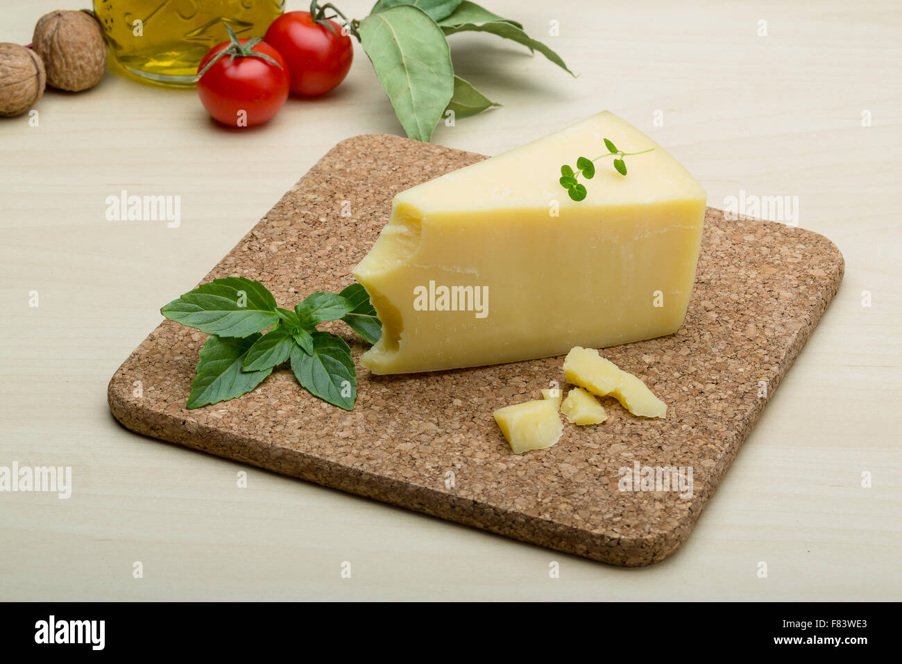 Parmesan cheese with basil leaves on the wood background Stock Photo ...