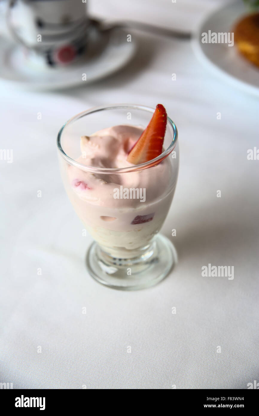 Pink Yoghurt with fresh red strawberry slice Stock Photo - Alamy