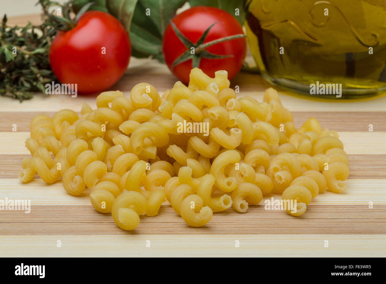 Raw Cellentani pasta on the wood background Stock Photo - Alamy