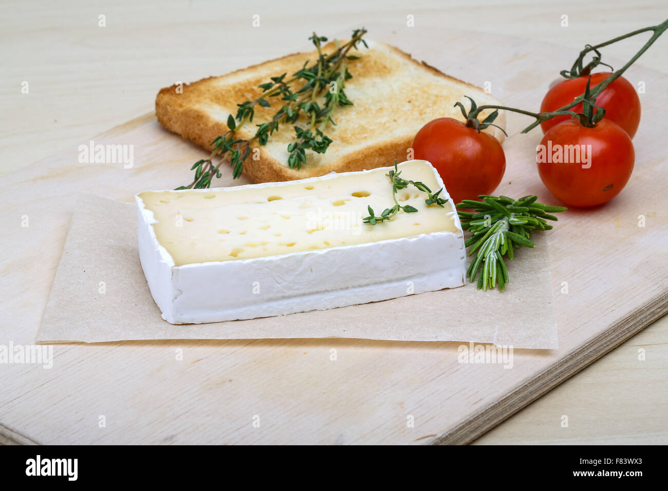 Soft brie cheese with rosemary, thyme and toast bread Stock Photo - Alamy