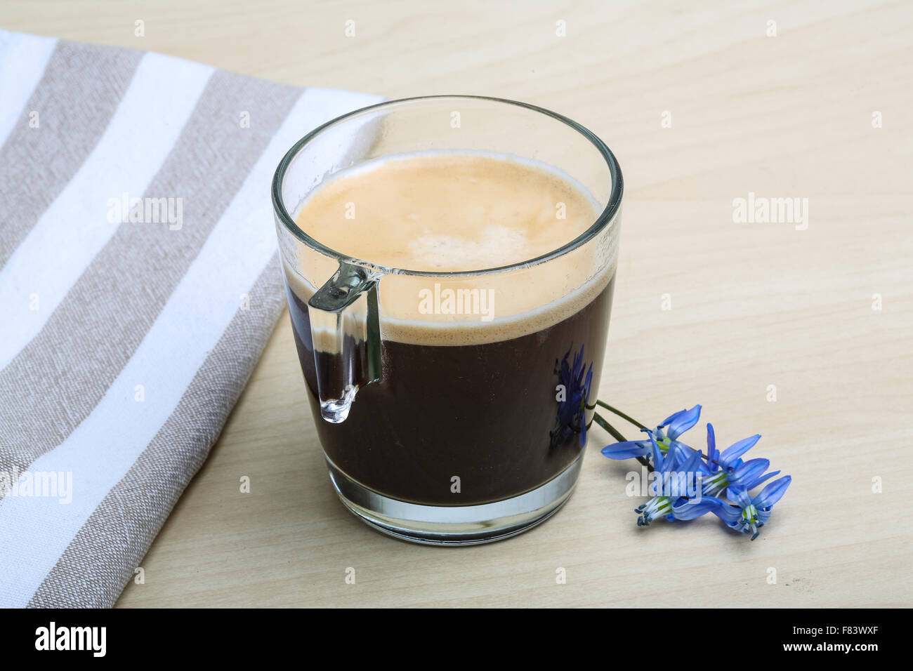 Hot Espresso coffee with blue spring flowers Stock Photo - Alamy