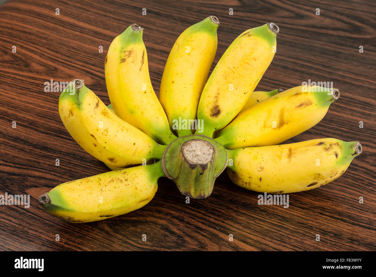 Fresh Baby bananas on the wood background Stock Photo - Alamy