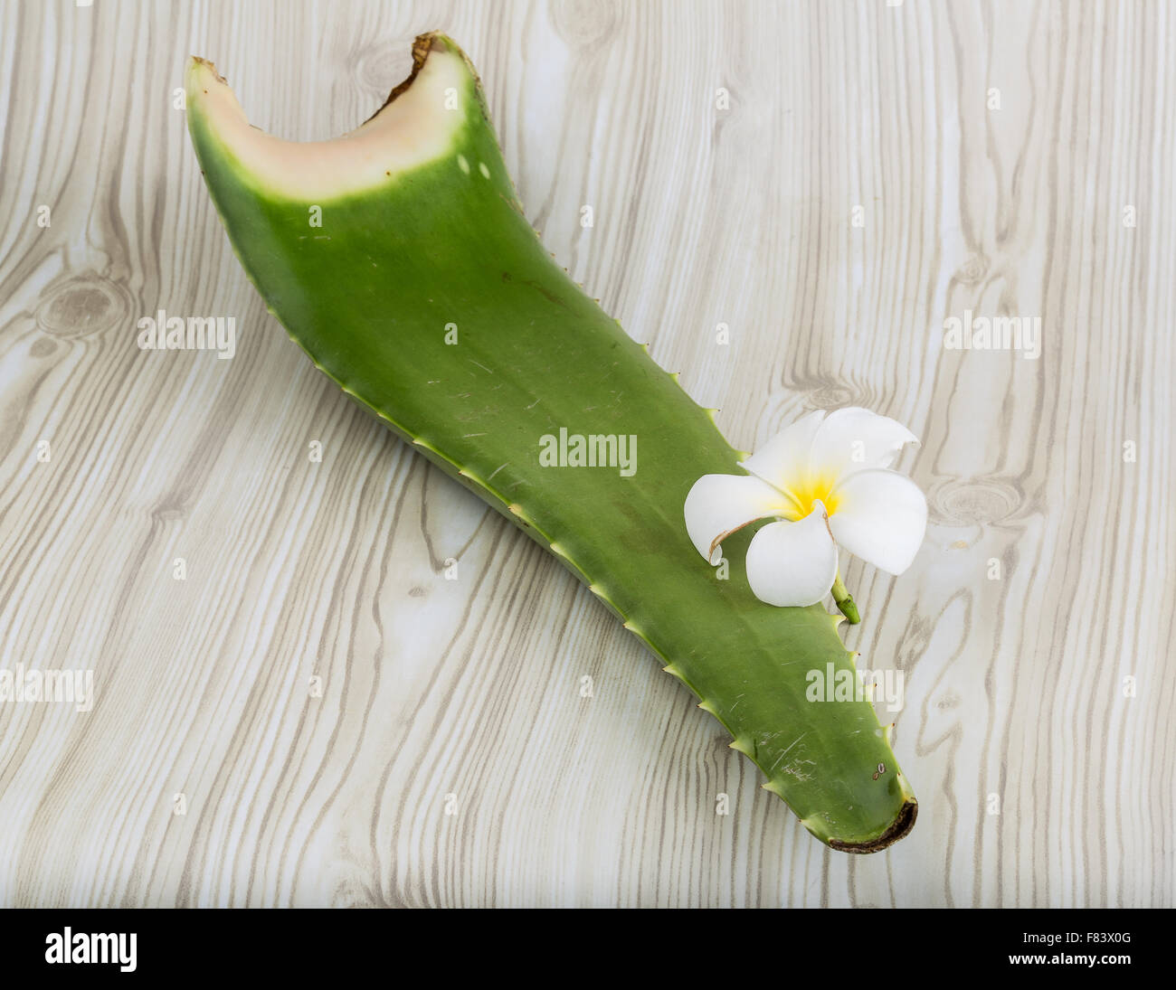 Aloe vera with plumeria flower on wood background Stock Photo - Alamy