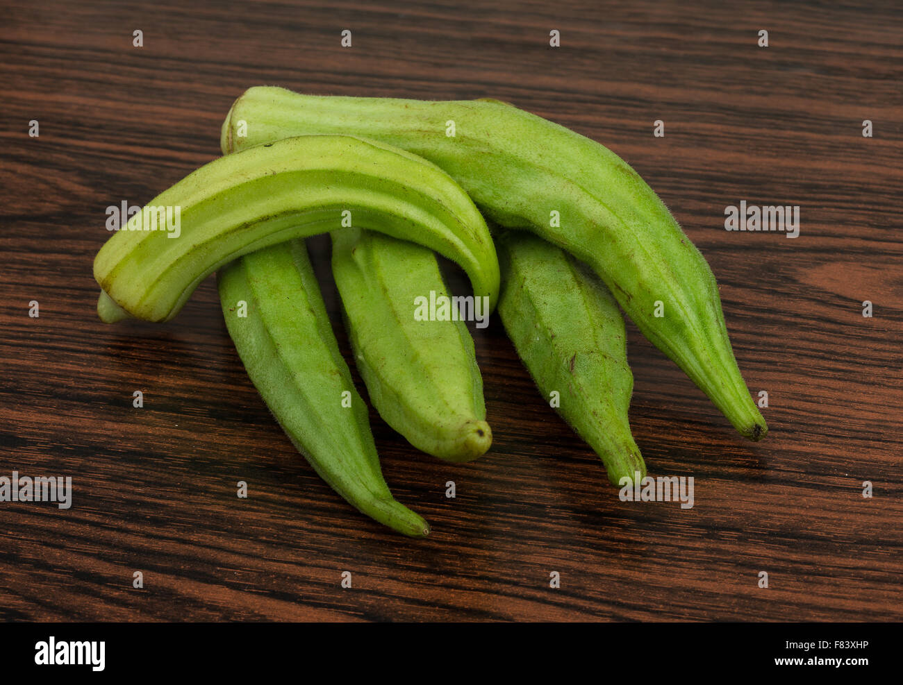 Asian vegetable - okra on the wood background Stock Photo - Alamy