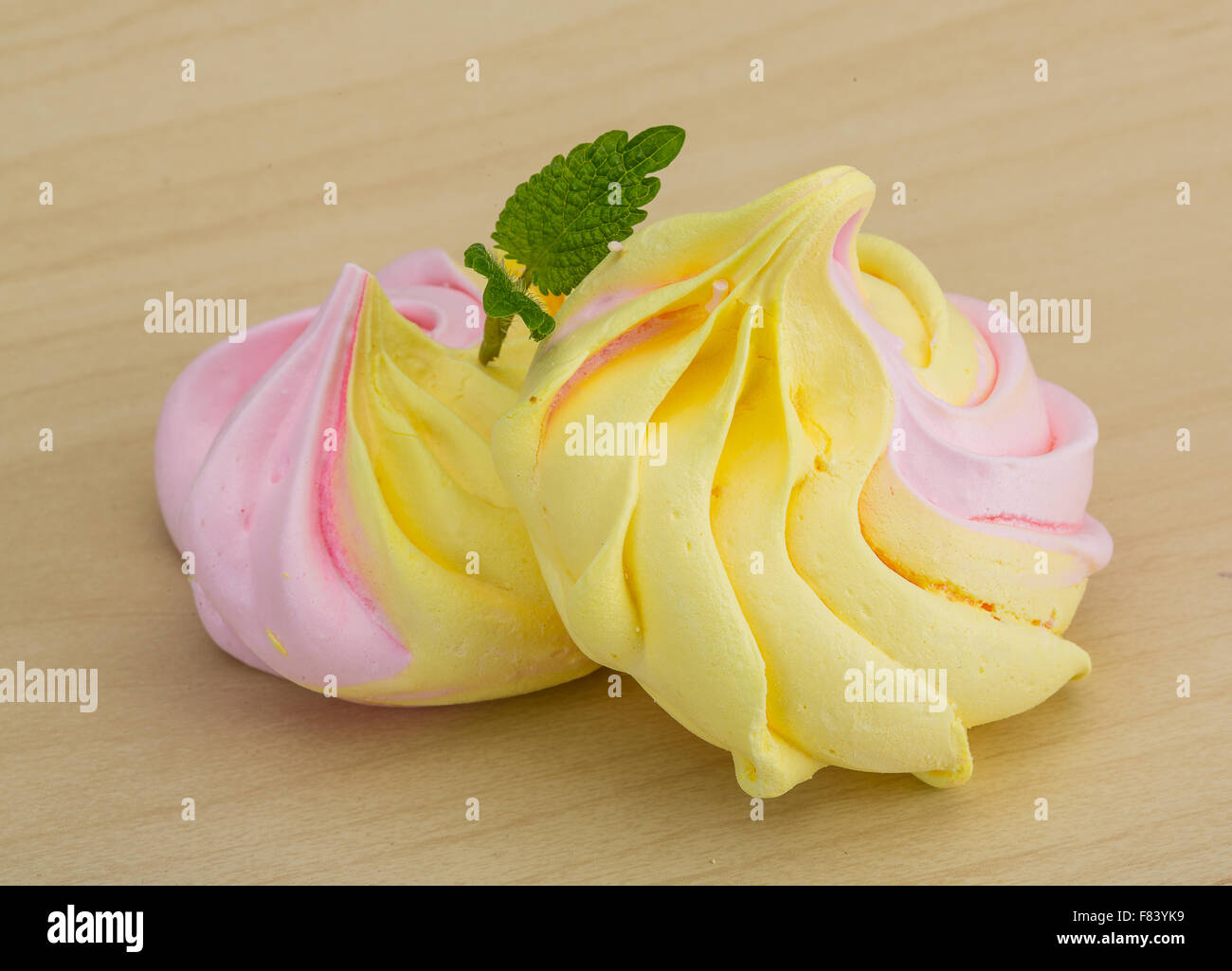 Yellow and rose meringue with melissa leaves Stock Photo - Alamy
