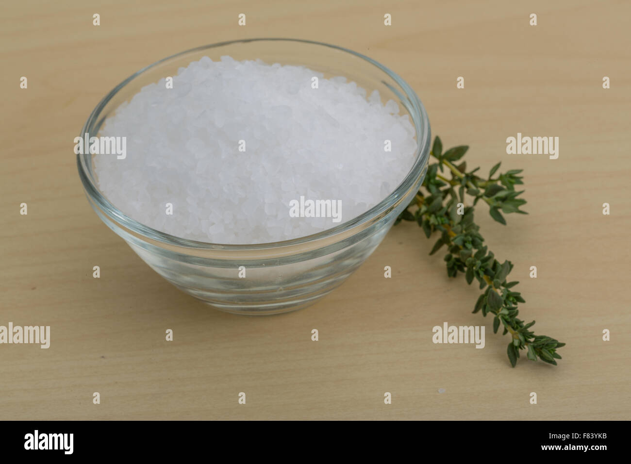 Sea salt heap crystal with thyme branch Stock Photo - Alamy